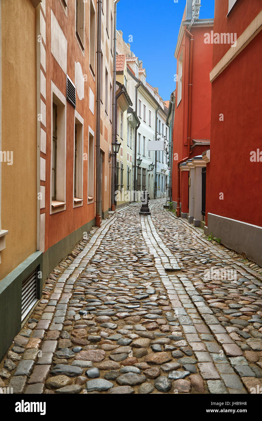 A narrow European street with paving stones in the old town in Riga on a summer sunny day Stock ...