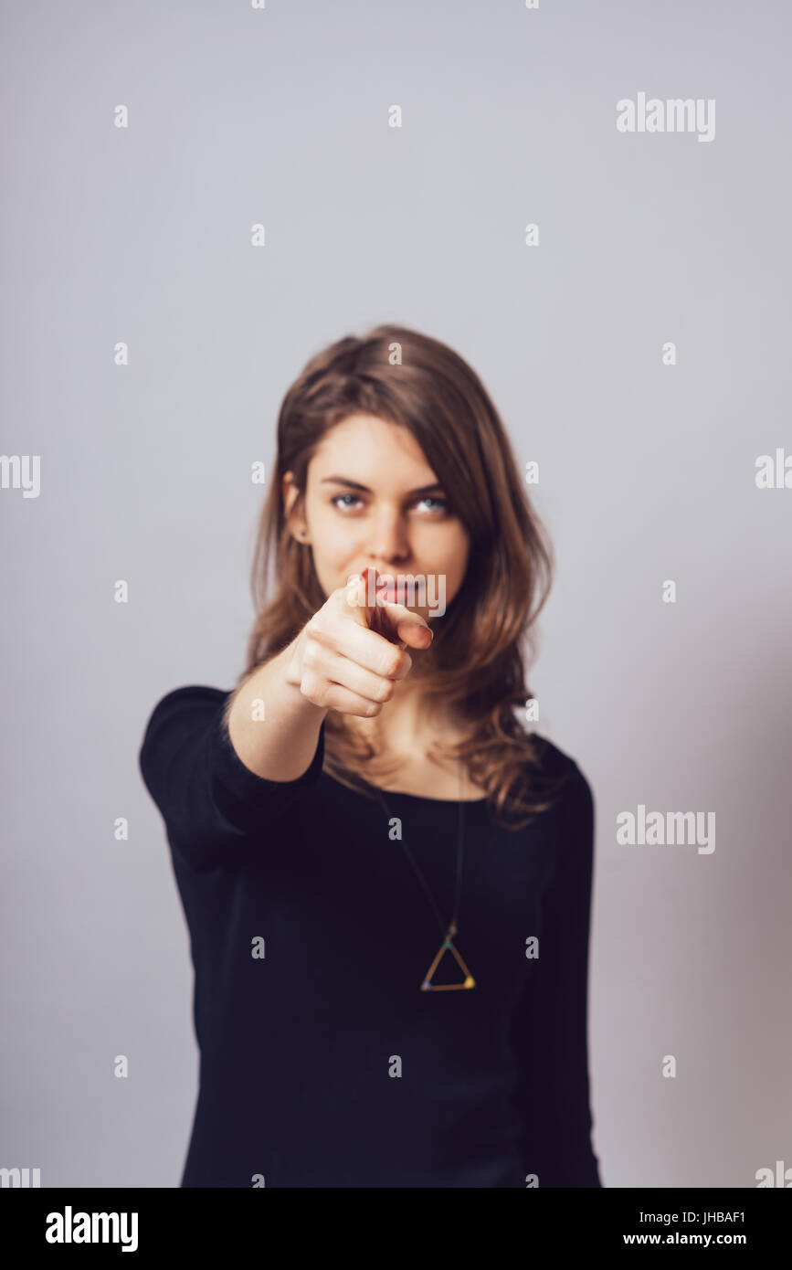 A woman shows a finger forward Stock Photo - Alamy
