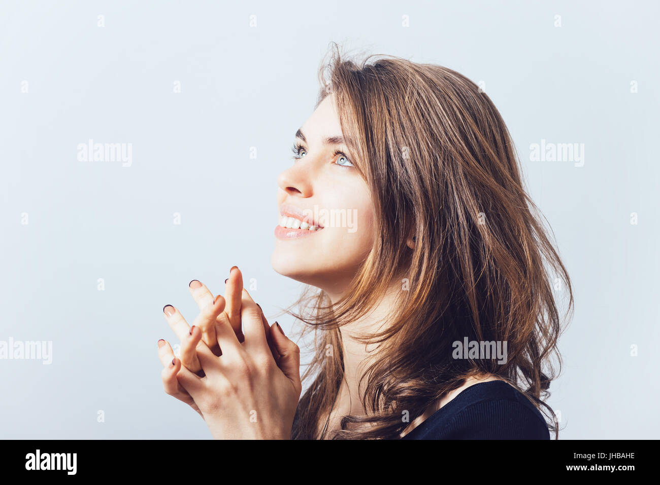 Closeup portrait of a young woman praying Stock Photo - Alamy