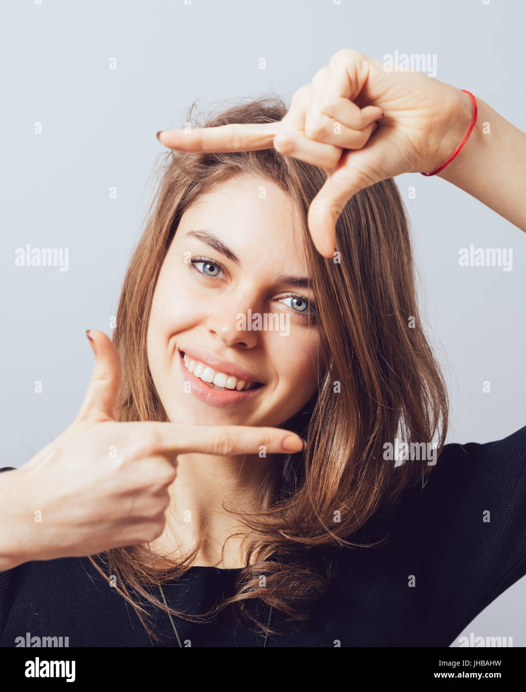 girl makes a frame arms Stock Photo - Alamy