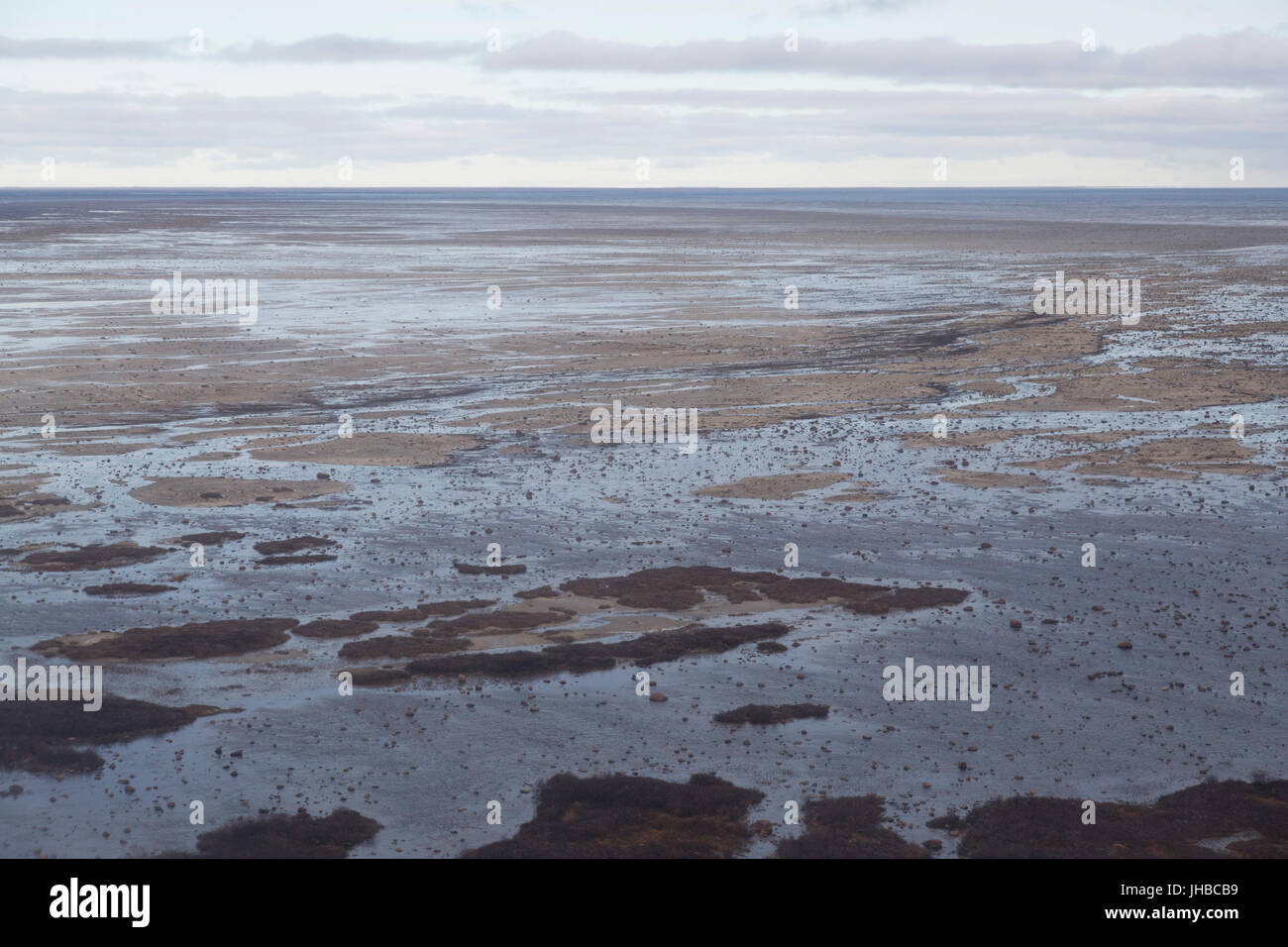 The semi-frozen coastline of the Hudson Bay north of Churchill in ...