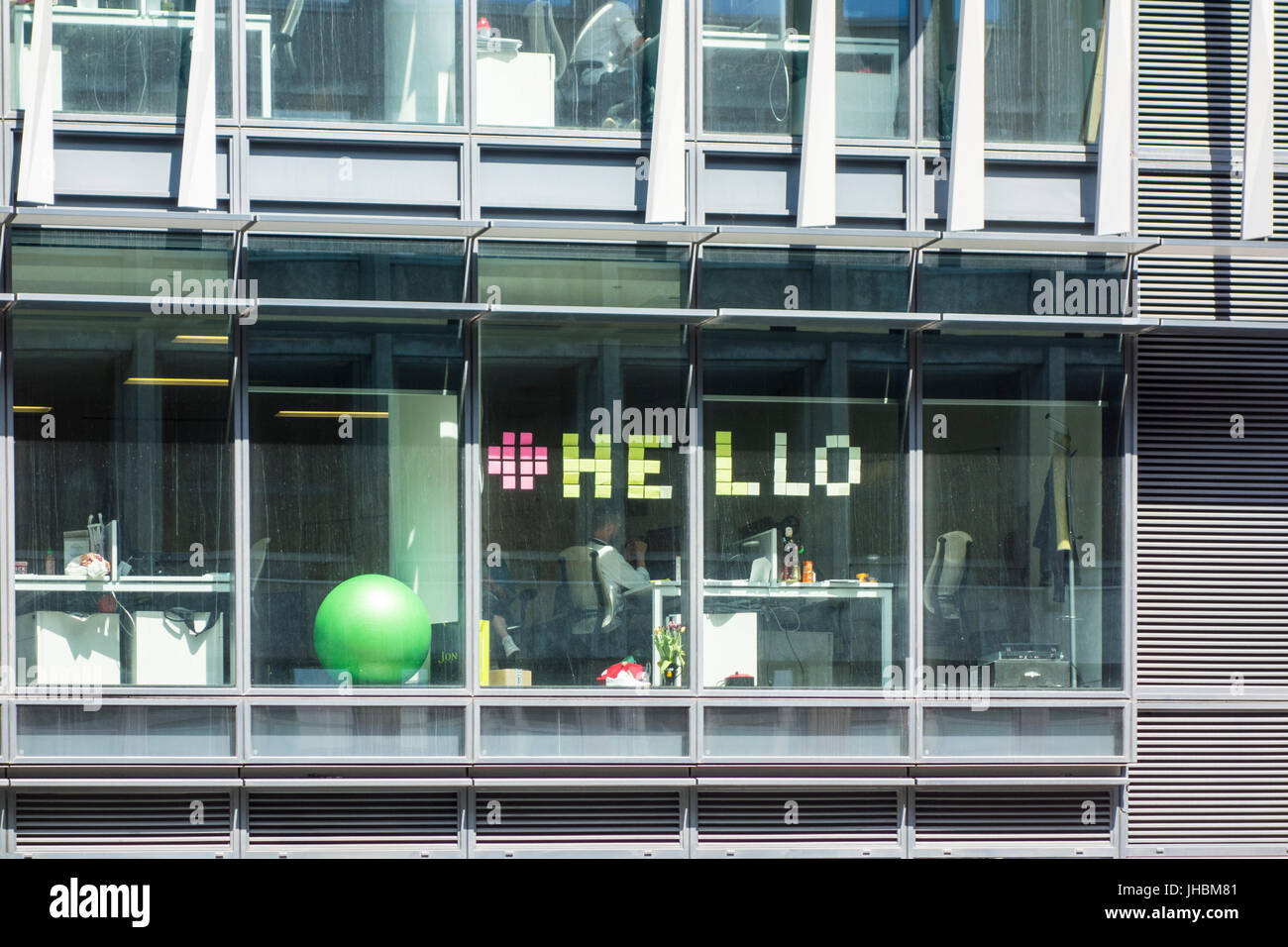 Office worker spells out 'hello' with post it notes on window, London ...