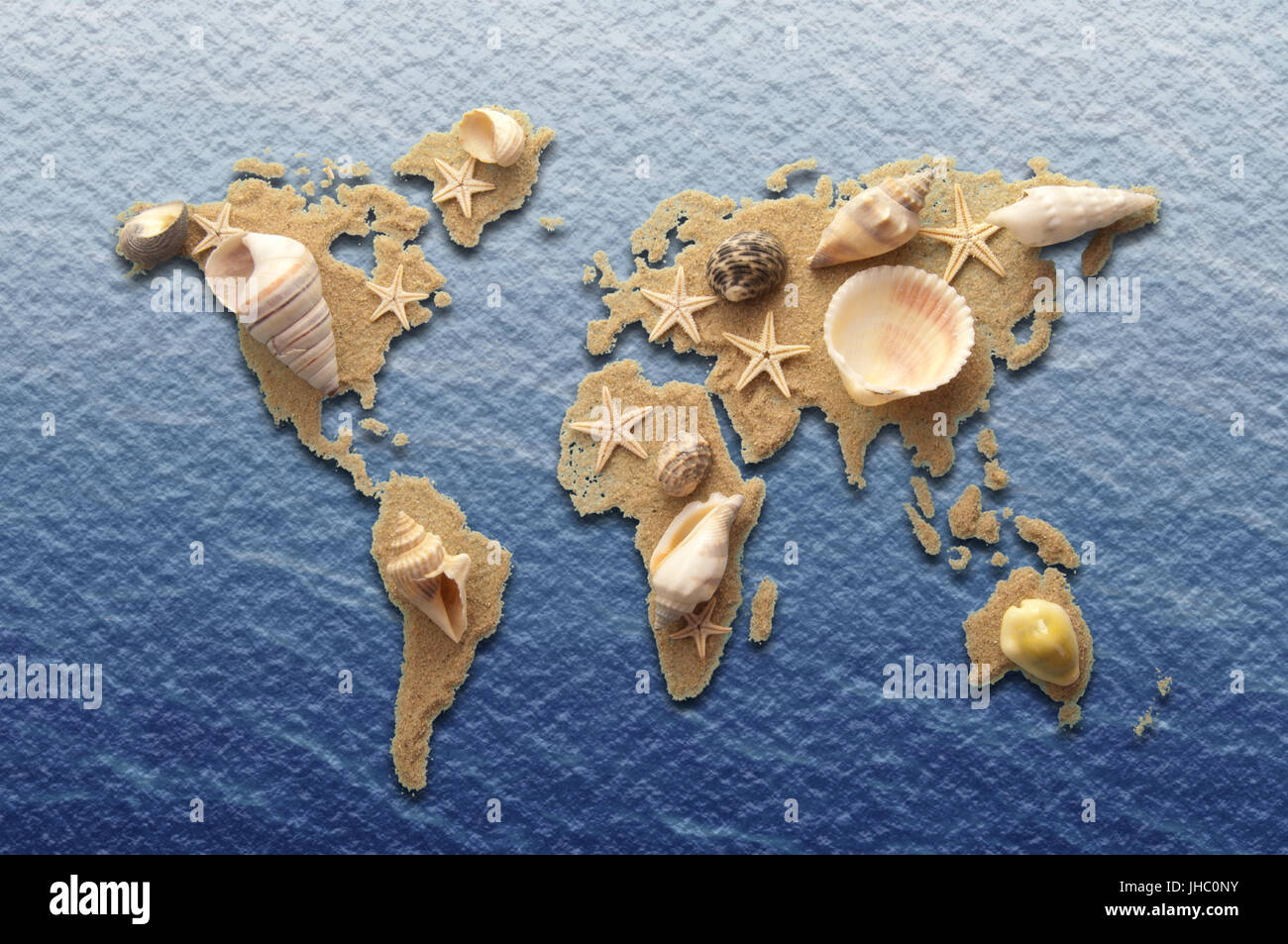 World atlas made from sand and sea shells on a sea background Stock ...