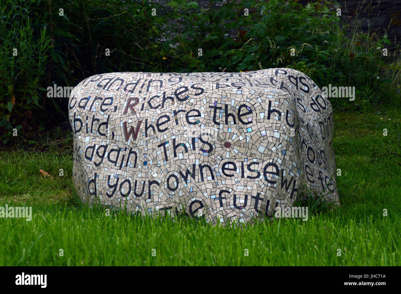 Words of a poem by Gwyneth Lewis inscribed in mosaic on a boulder at ...