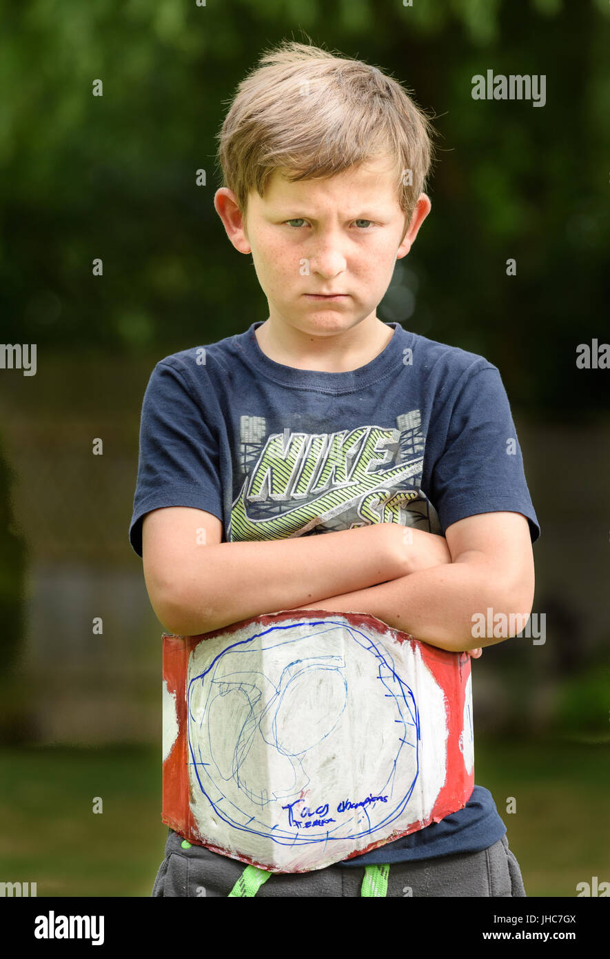 young boy home-made wrestling belt pride self-important cardboard pose ...