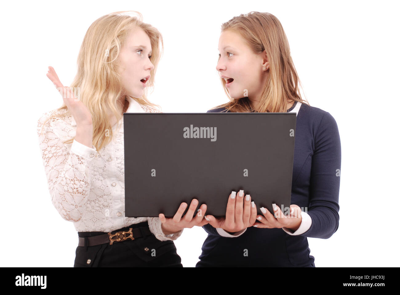 Two shocked girls using laptop isolated on a white background Stock ...