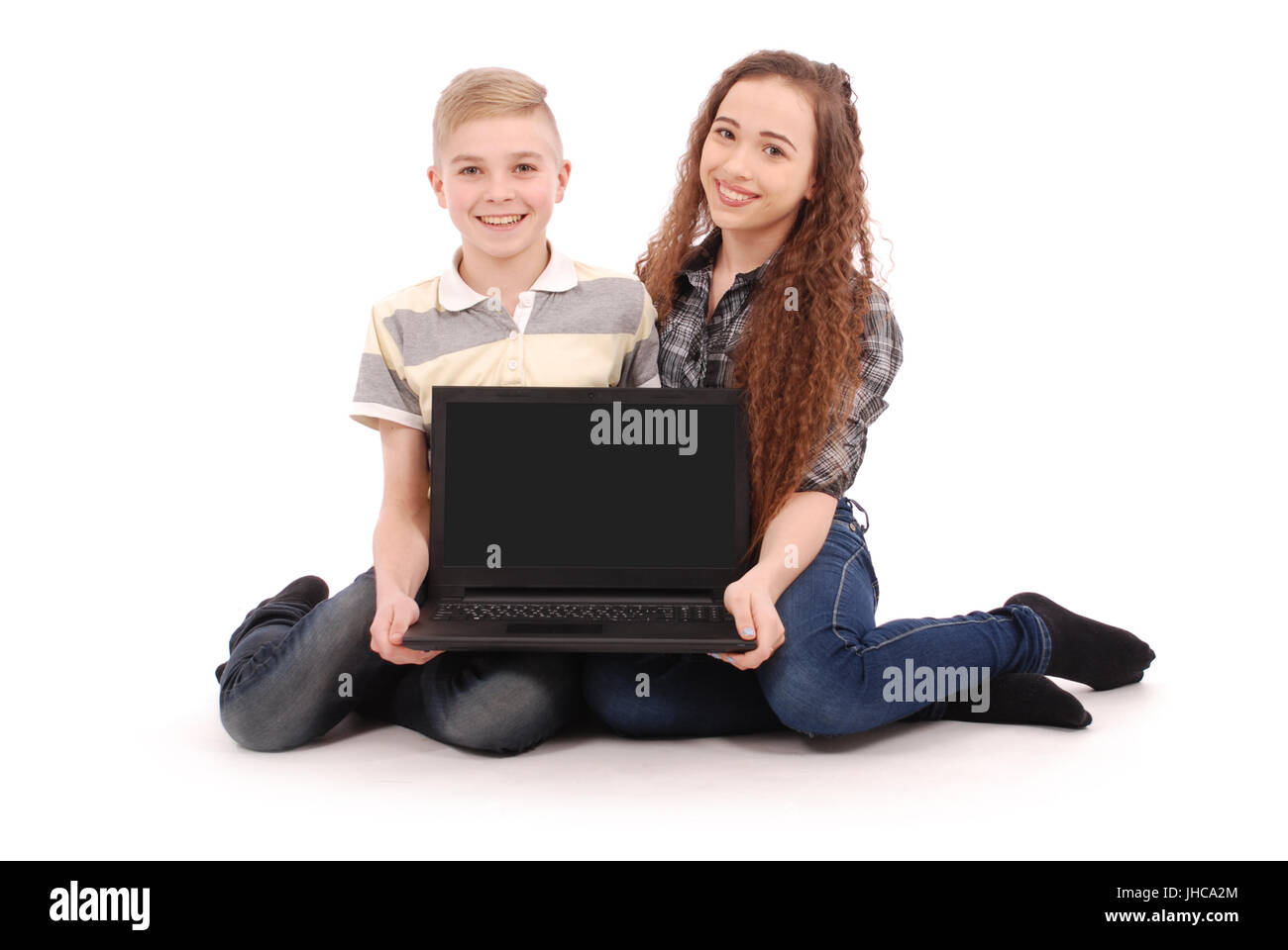 Boy and girl using a laptop isolated on white background Stock Photo ...