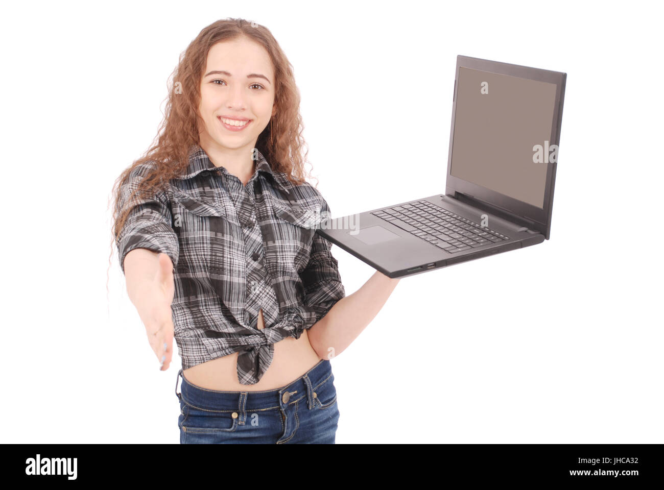 Young girl standing and using a laptop, isolated on white Stock Photo ...