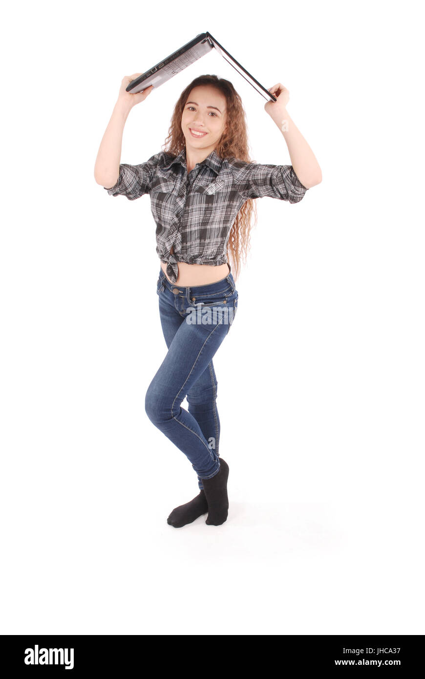 Young girl standing and using a laptop, isolated on white Stock Photo ...