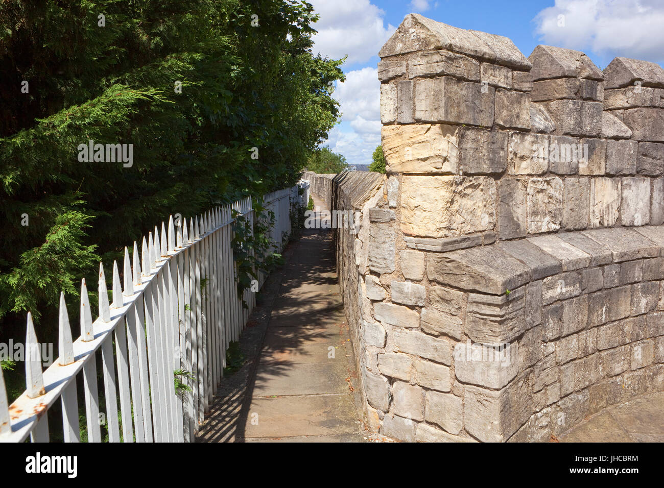 a scenic section of the historic city walls in york under a blue summer ...