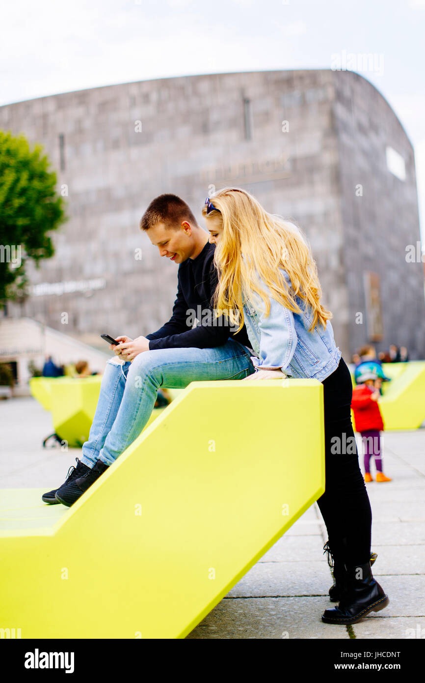 Young people sitting on the modern bench on street in Vienna, Austria ...