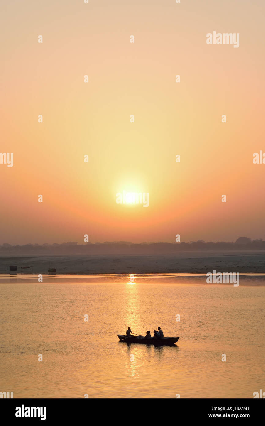 Fishermen on wooden boats at Ganges river in Varanasi India. Due to ...
