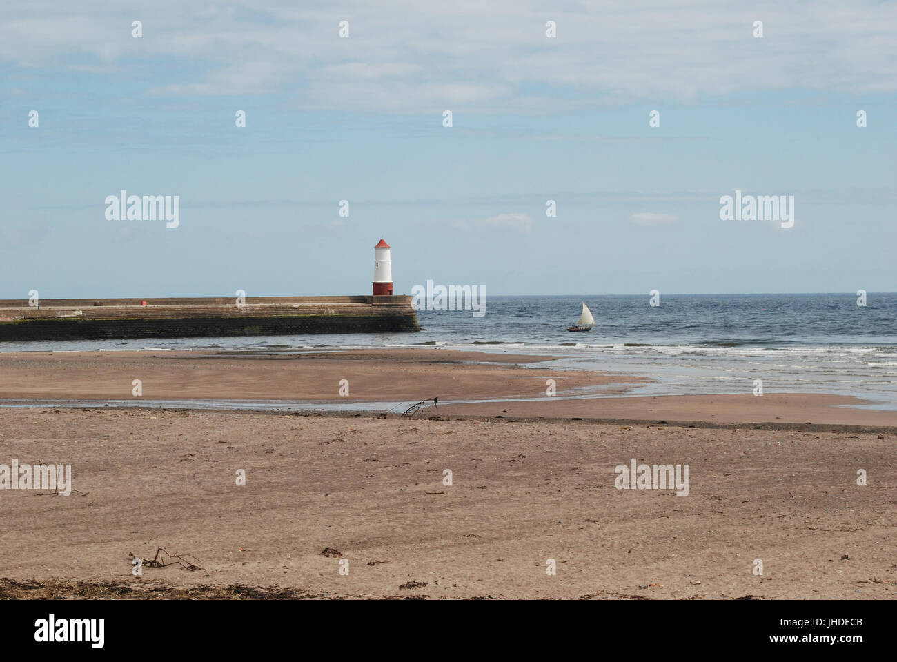 lighthouse, beach and old sailing yacht at Spittal Stock Photo - Alamy