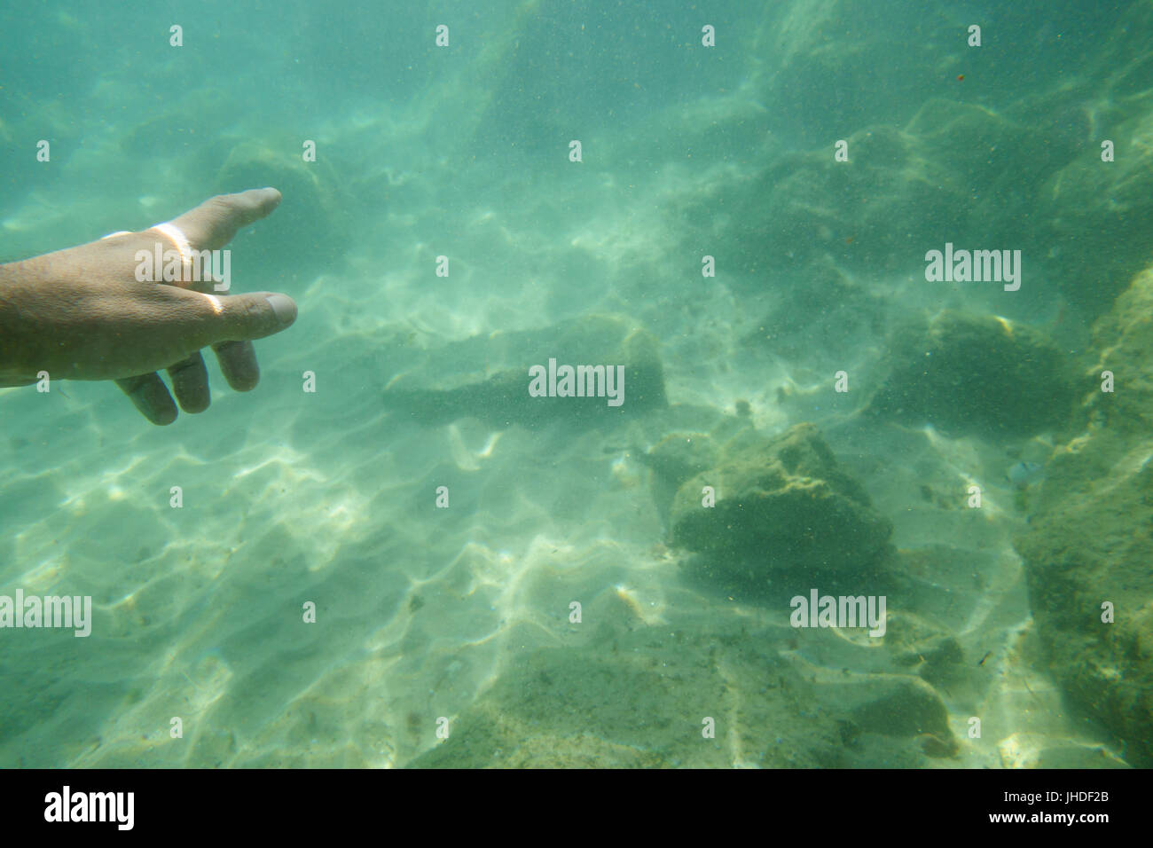 Human hand exploring underwater in clear sea Stock Photo - Alamy