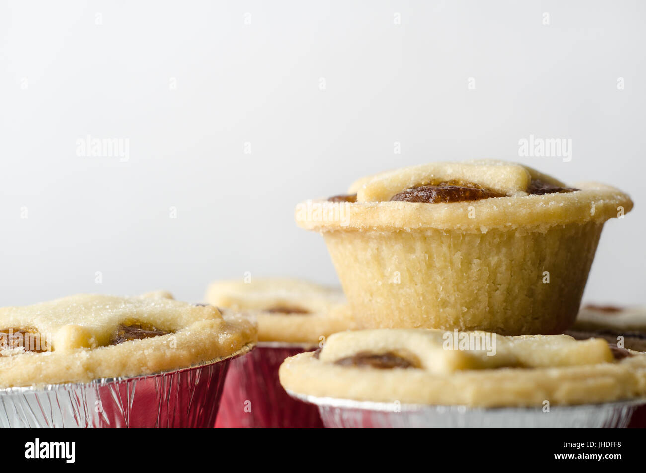 An eye level view of a stack of Christmas Mince Pies with star shaped ...