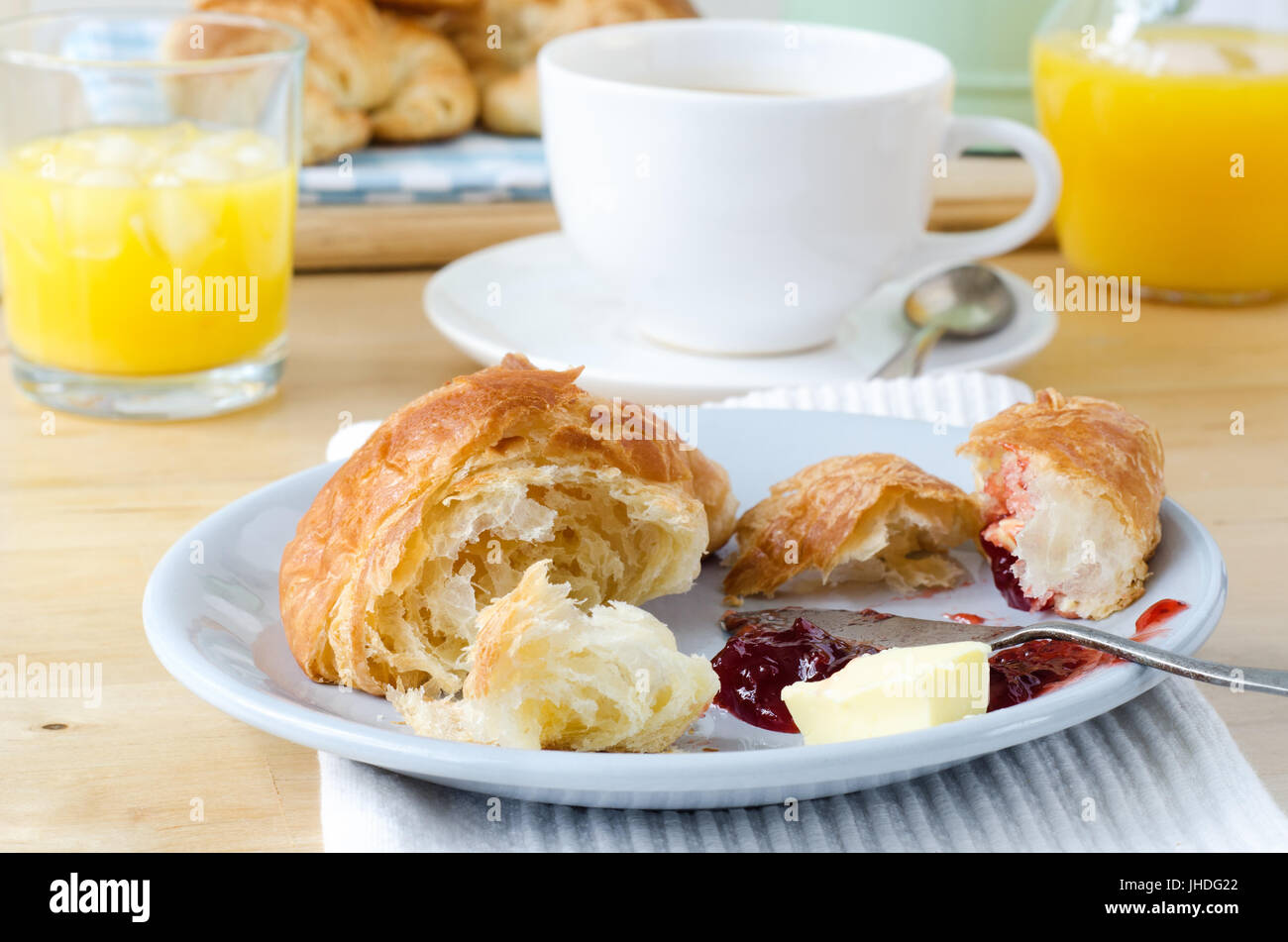 Continental Breakfast table setting laid with croissants, orange juice ...