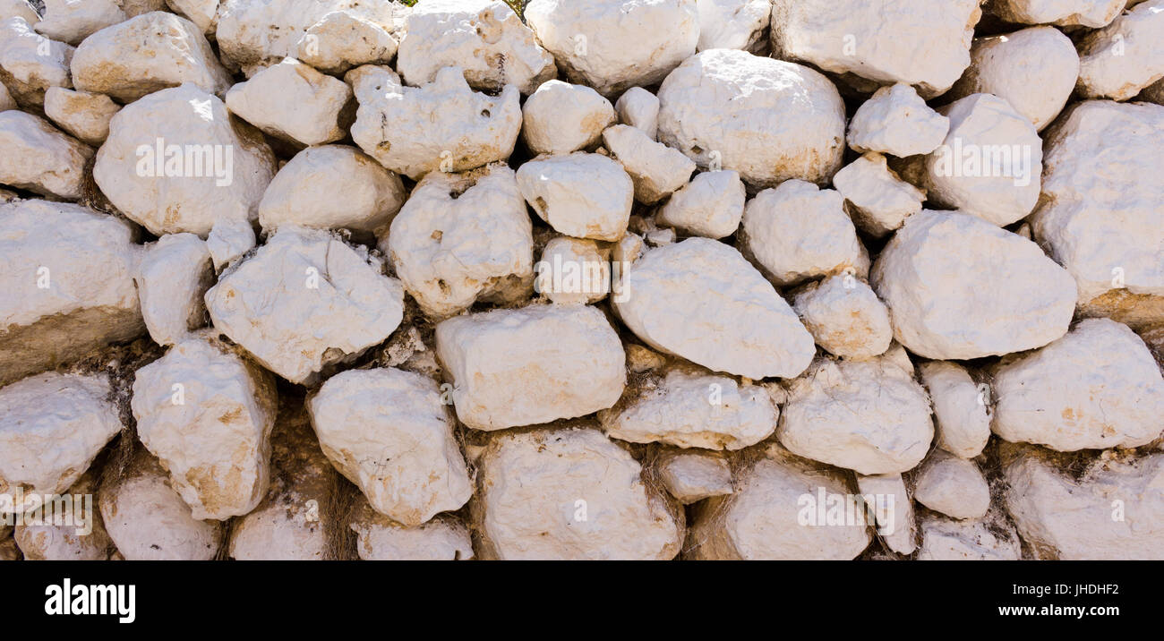 white stones stacked to a wall Stock Photo - Alamy