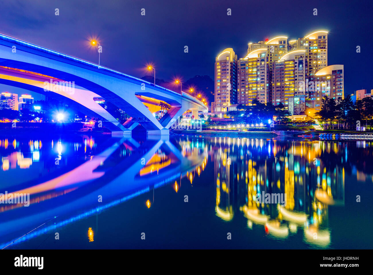 Riverside night view of bridge and architecture Stock Photo - Alamy