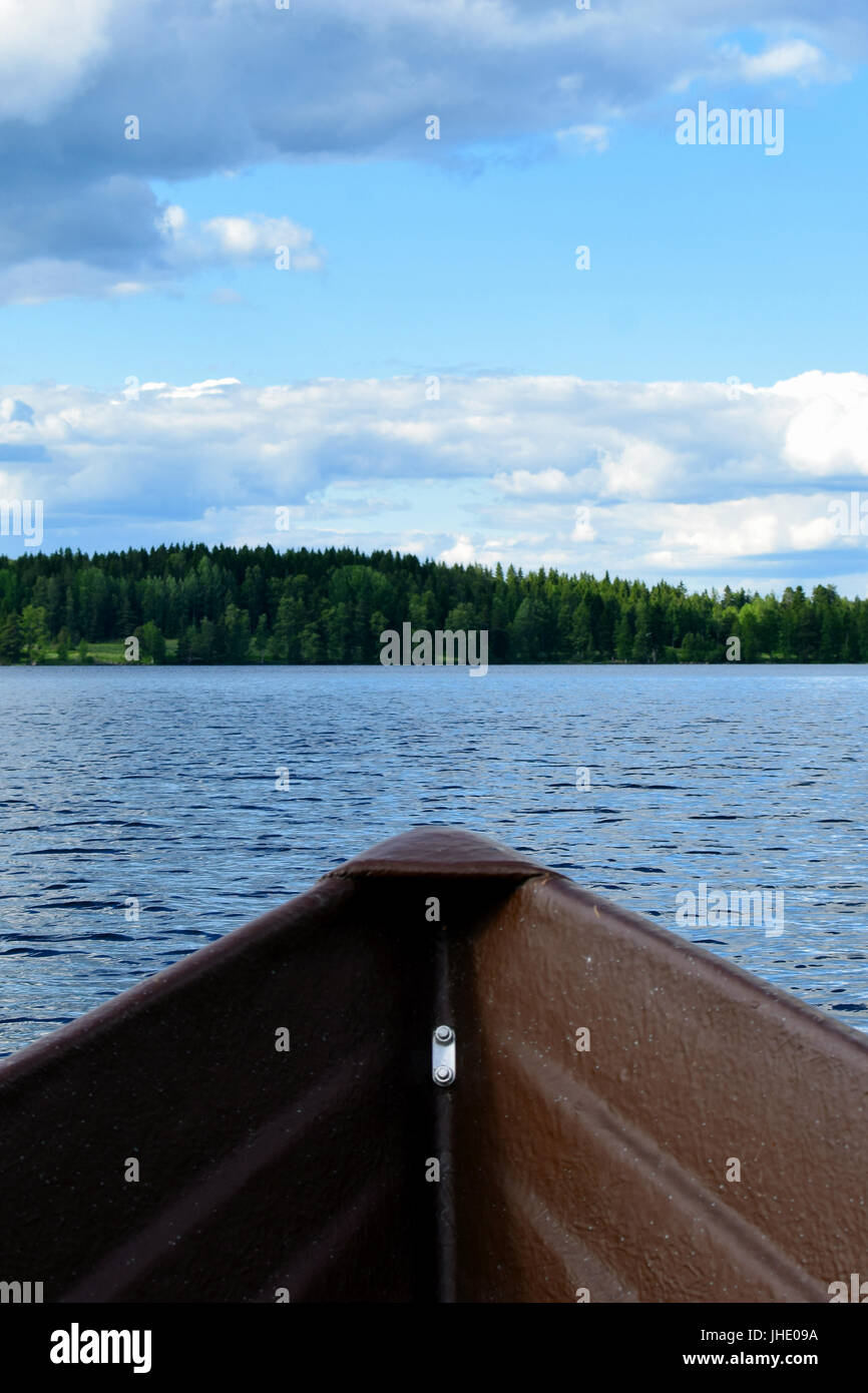 Bow of brown rowing boat on lake in Finland Stock Photo - Alamy