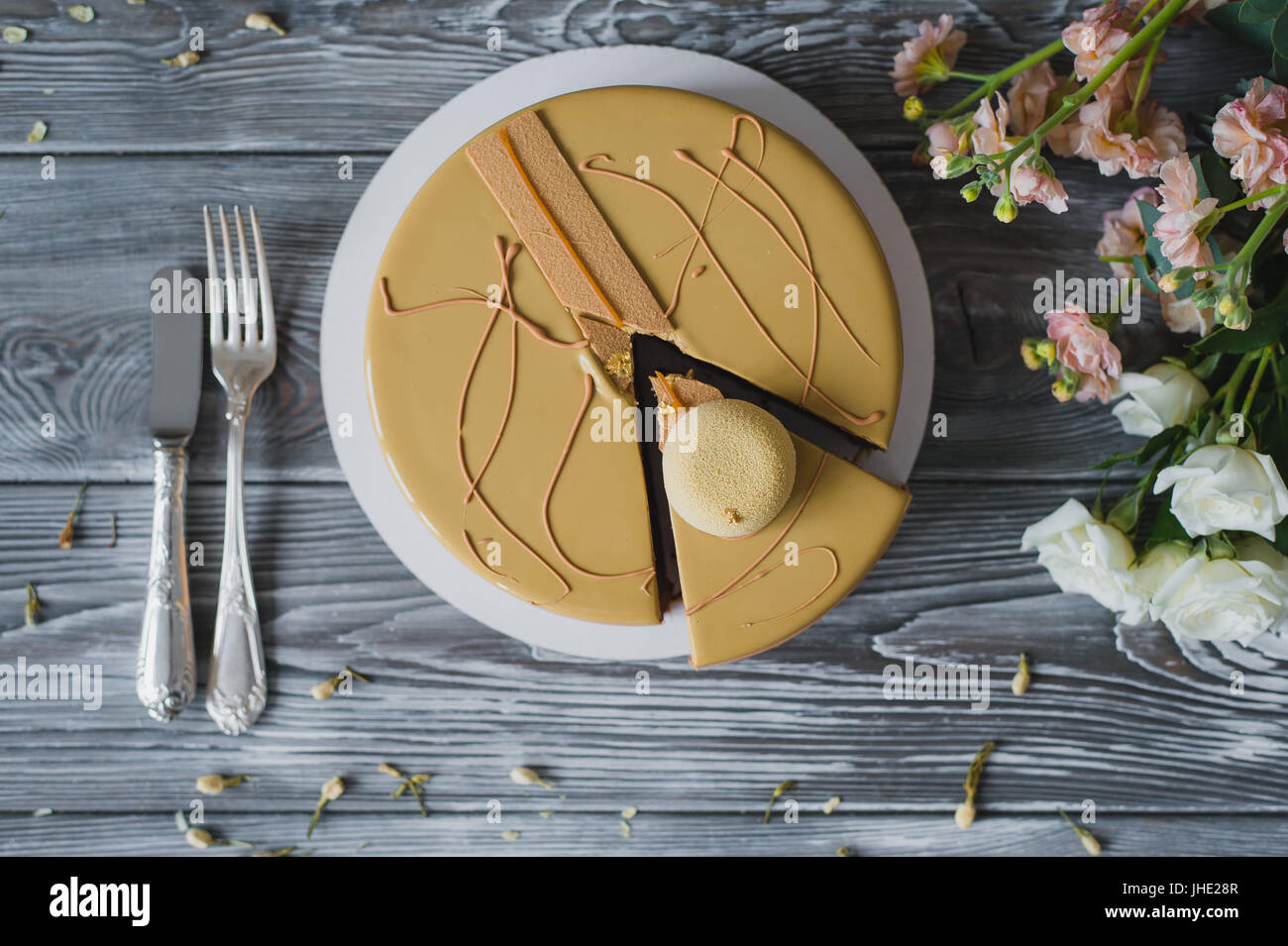 Bakery with piece of unusual yellow mousse cake with almond dacquoise ...