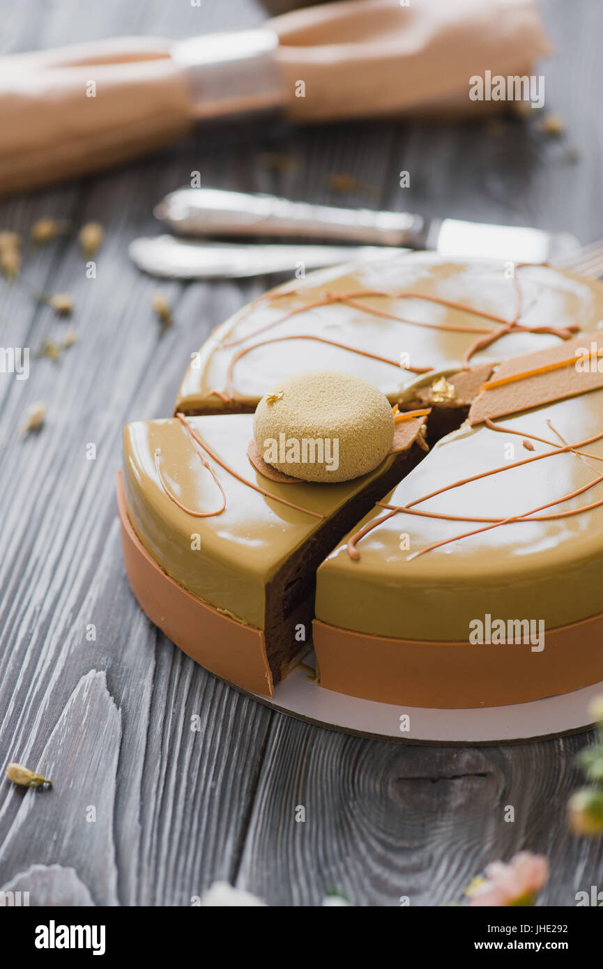 Bakery with piece of unusual yellow mousse cake with almond dacquoise ...