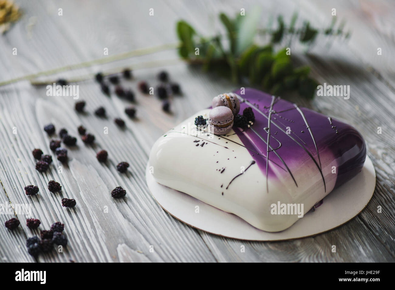 Hands going to eat dessert, yellow mousse cake with almond dacquoise ...