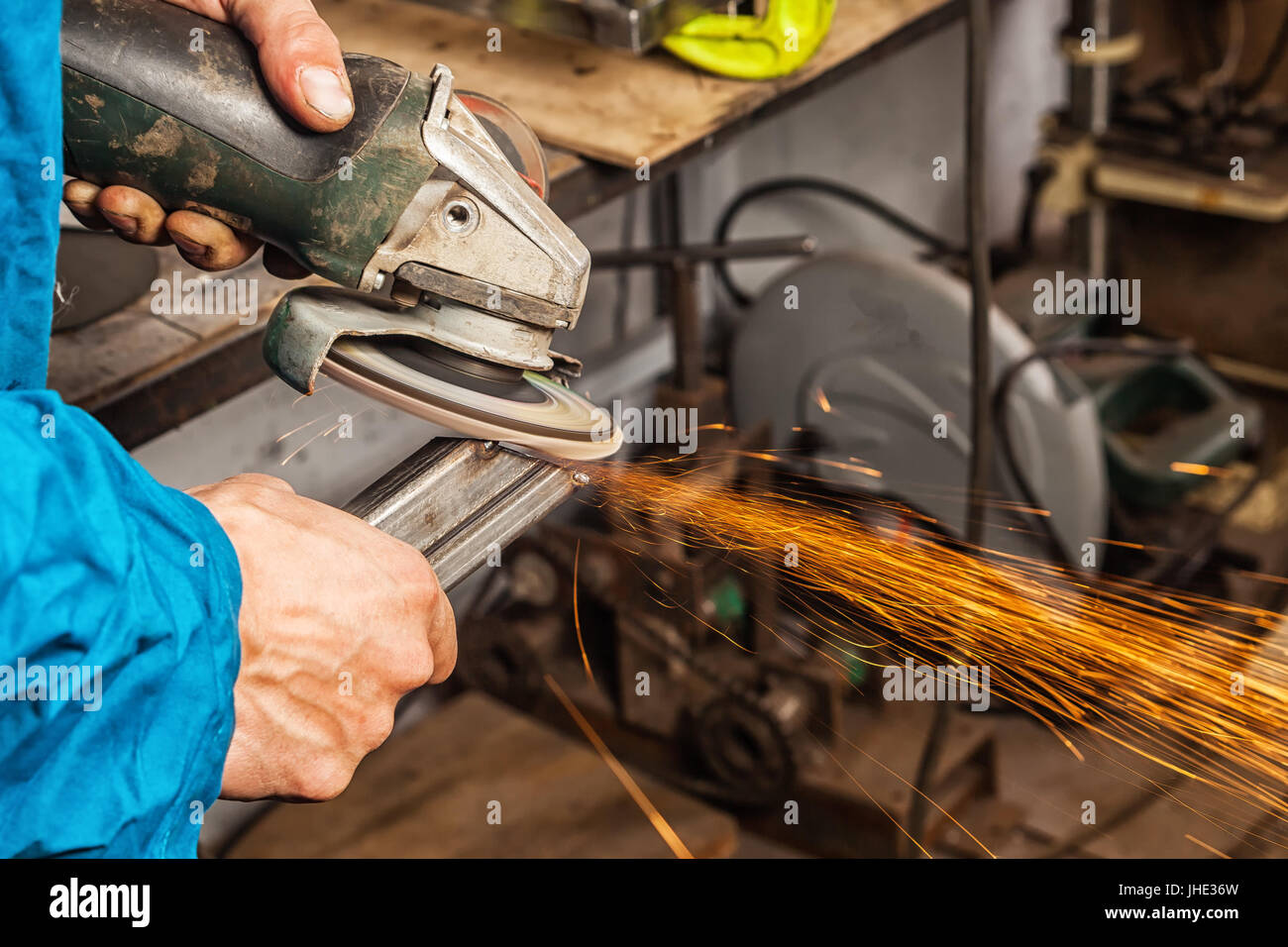 Close up man welder grinder metal an angle grinder in the garage Stock ...