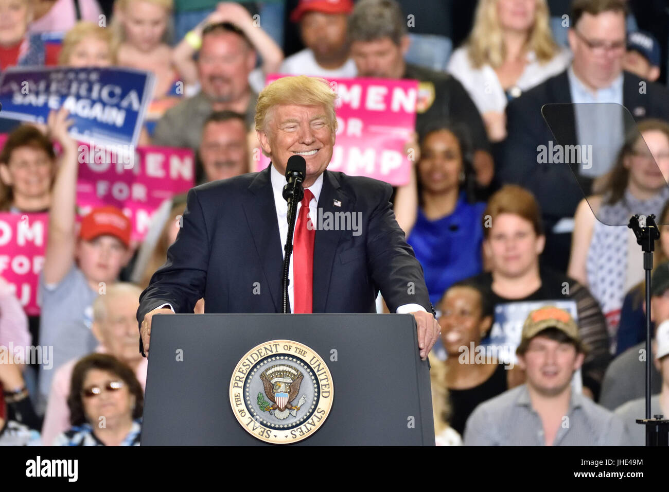 President Donald Trump smiles on stage as he delivers a campaign rally ...