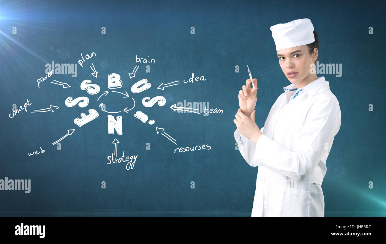Beautiful medical woman doctor in uniform. Studio painted background ...