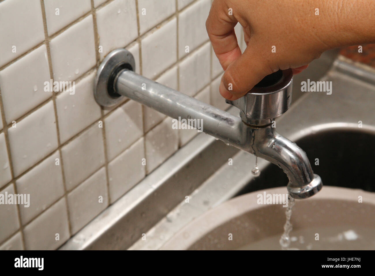 Hand closing tap water hi-res stock photography and images - Alamy