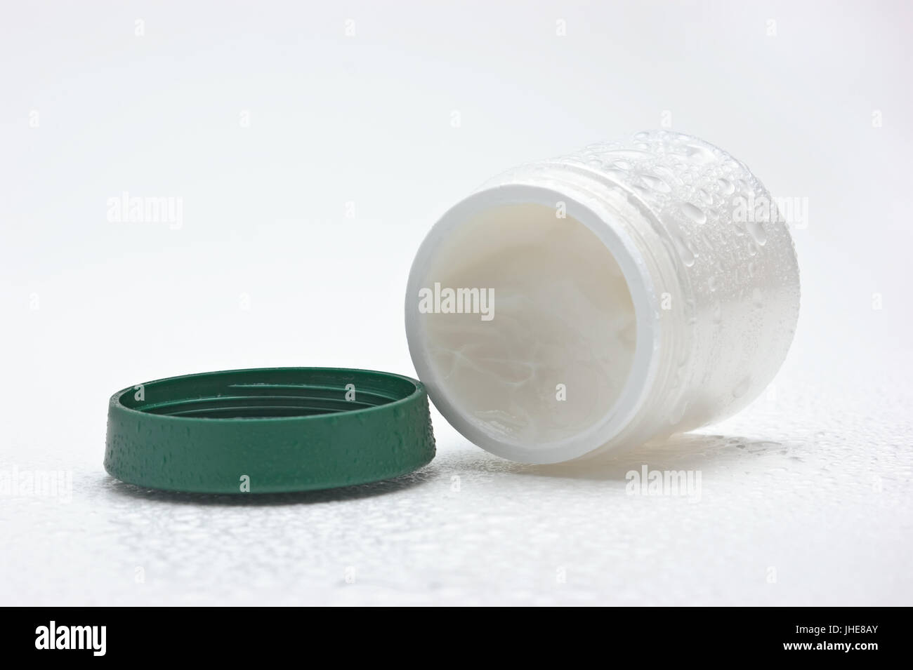 open cosmetic cream jar wet Stock Photo - Alamy