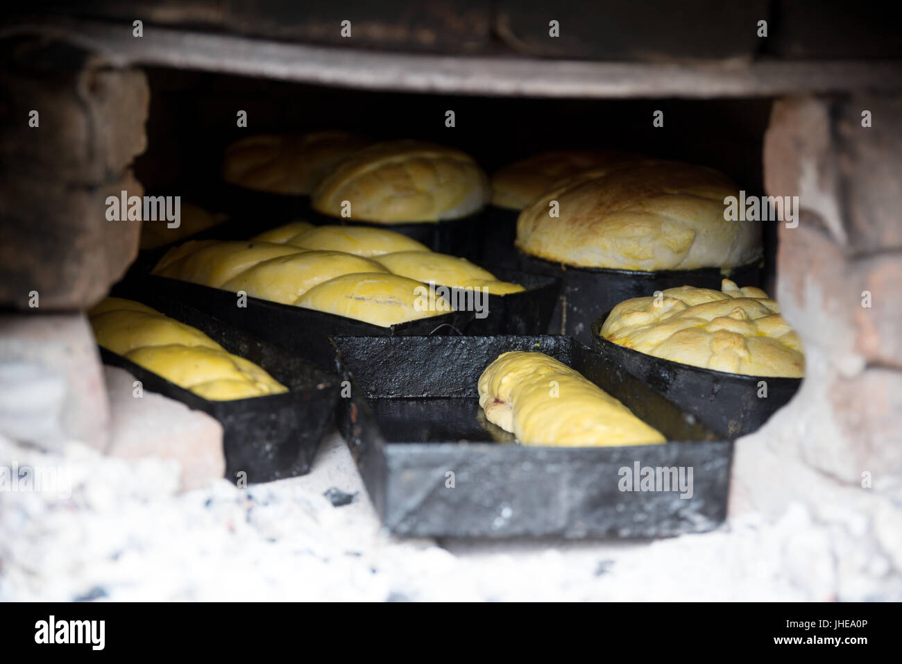 Traditional Easter bread and cakes cooking in an outdoor oven, Breb ...