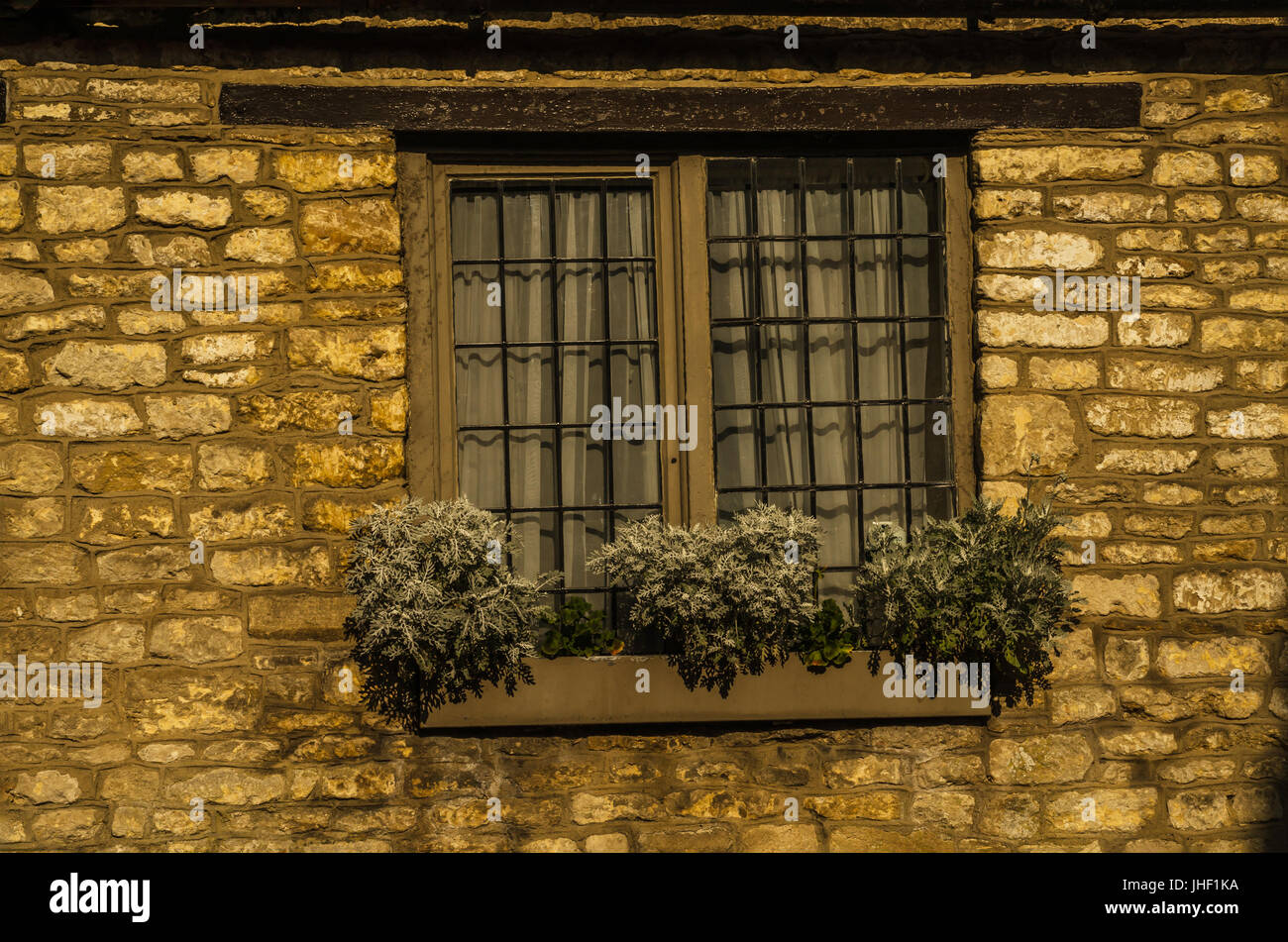 Old wooden window in a historic building, characteristic stone facade ...