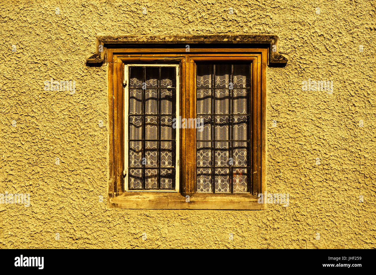 Old wooden window in a historic building, characteristic stone facade ...
