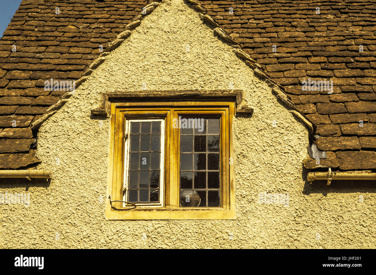 Old wooden window in a historic building, characteristic stone facade ...