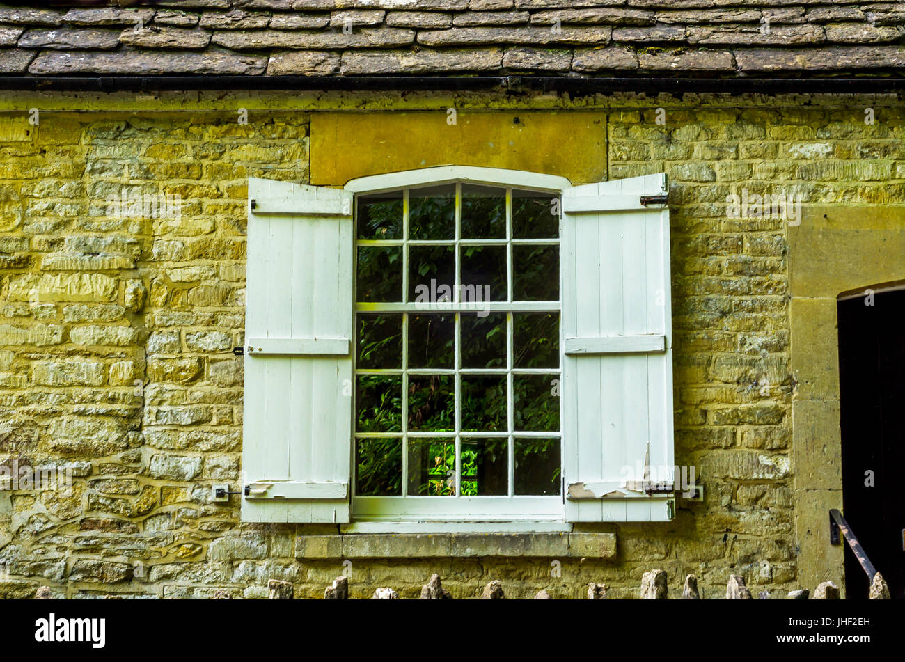 Old wooden window in a historic building, characteristic stone facade ...