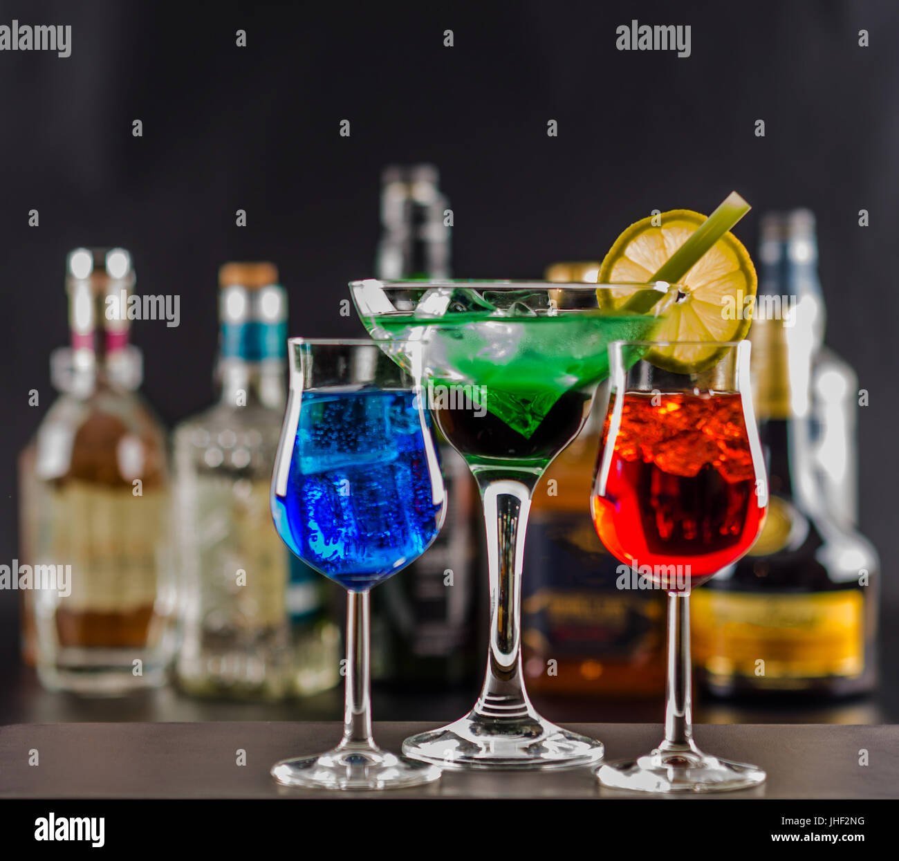Colorful drink on the background of bottles in original shapes ...