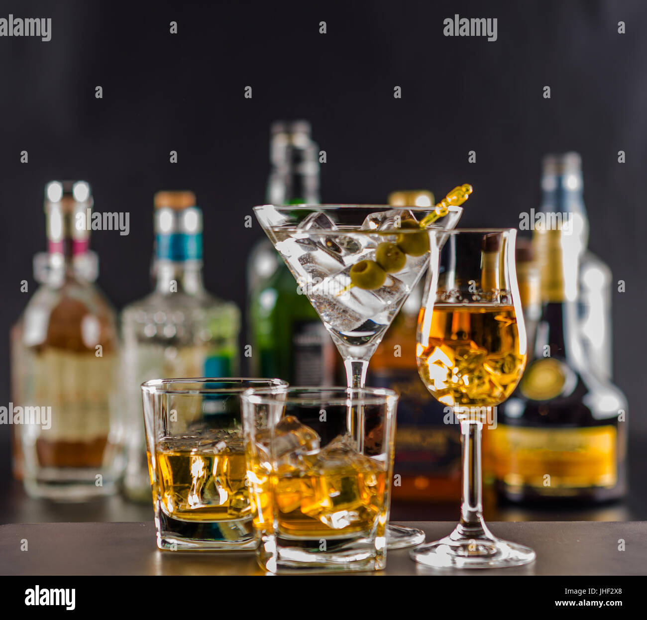 Colorful drink on the background of bottles in original shapes ...
