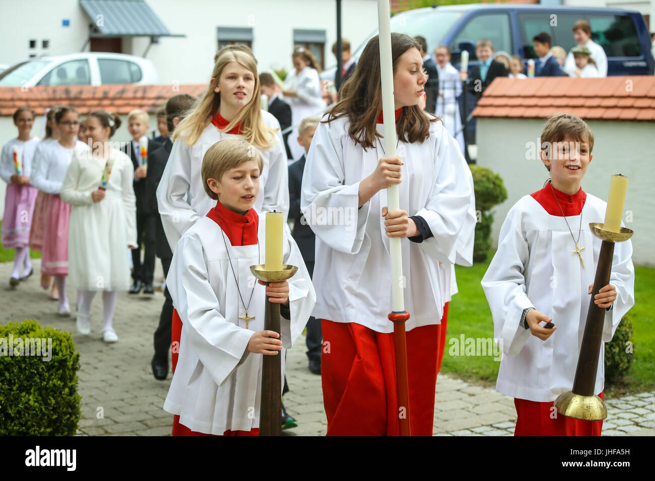 NANDLSTADT, GERMANY - MAY 7, 2017 : A group of altar servers holding ...