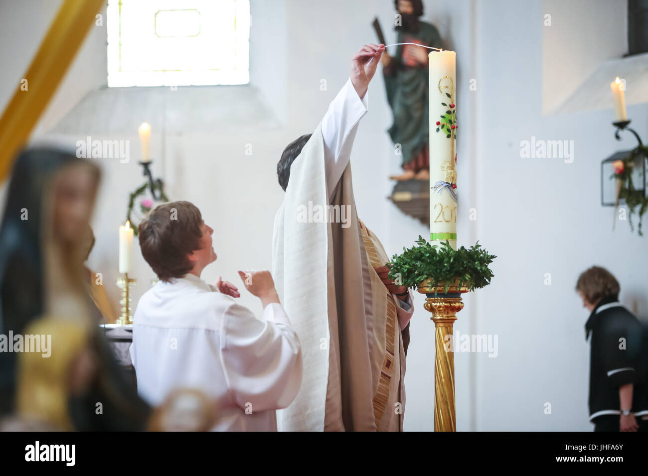 NANDLSTADT, GERMANY - MAY 7, 2017 : The priest and his assistant ...