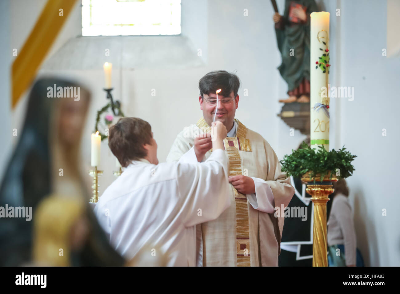 NANDLSTADT, GERMANY - MAY 7, 2017 : The priest and his assistant ...
