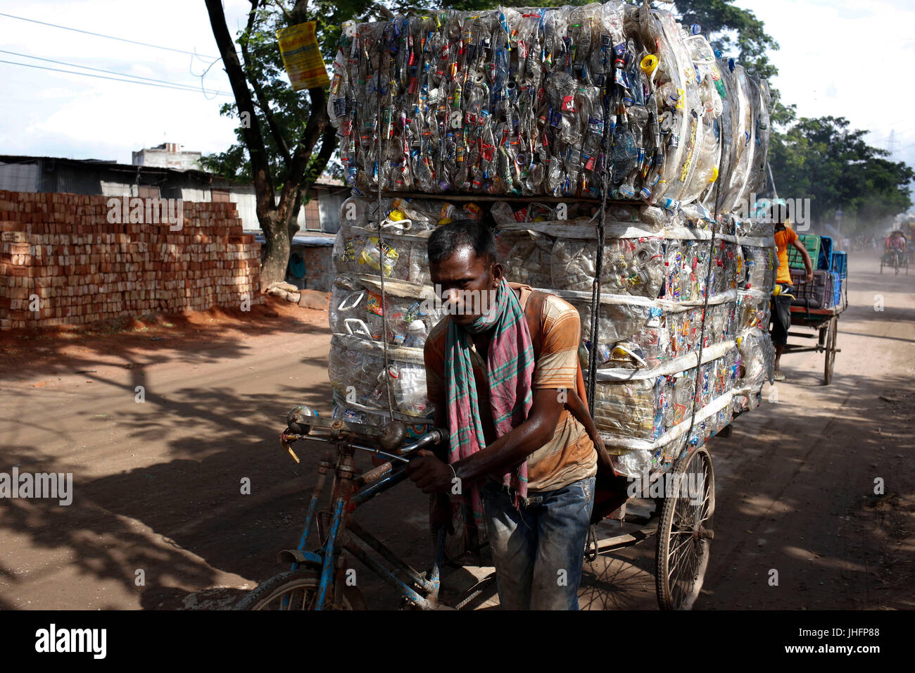 Dhaka, Bangladesh. 13th July, 2017. A van puller is delivering plastic ...