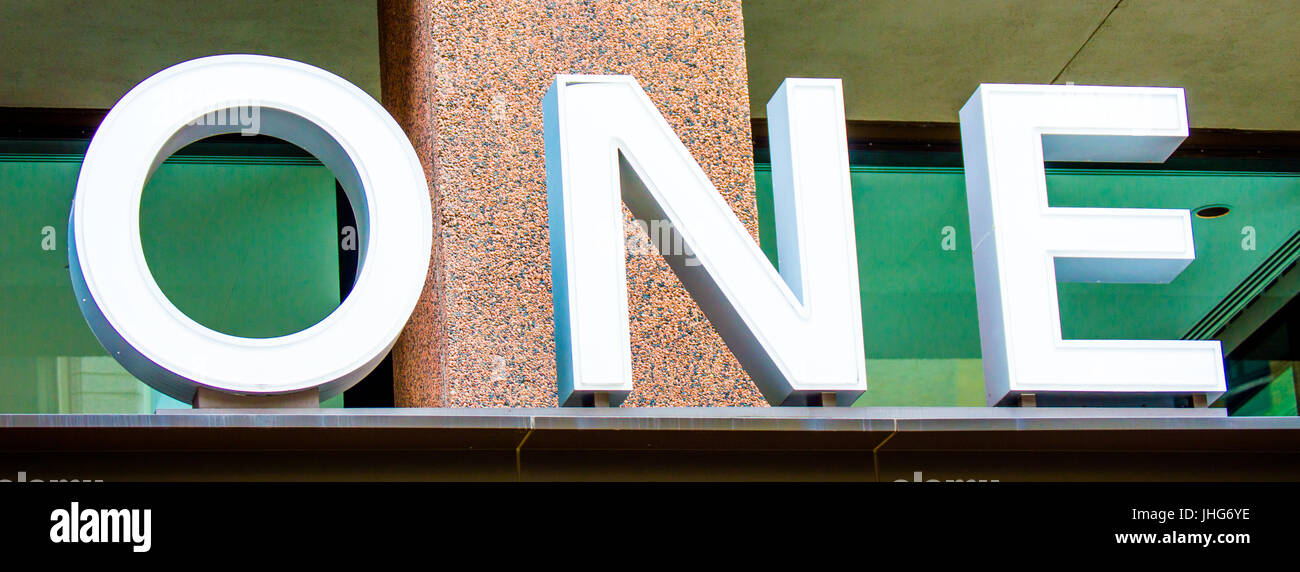 building sign saying "ONE" in white letters Stock Photo - Alamy
