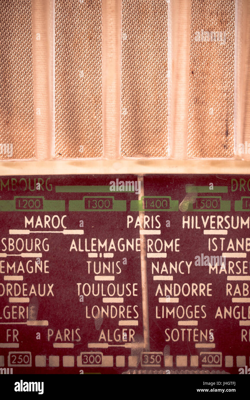 Detail take of a vintage radio receiver dial with the names of ...