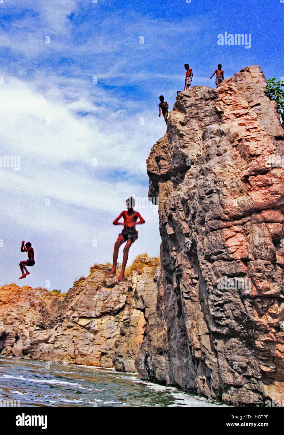 Kids Jumping into the river from cliff Stock Photo - Alamy