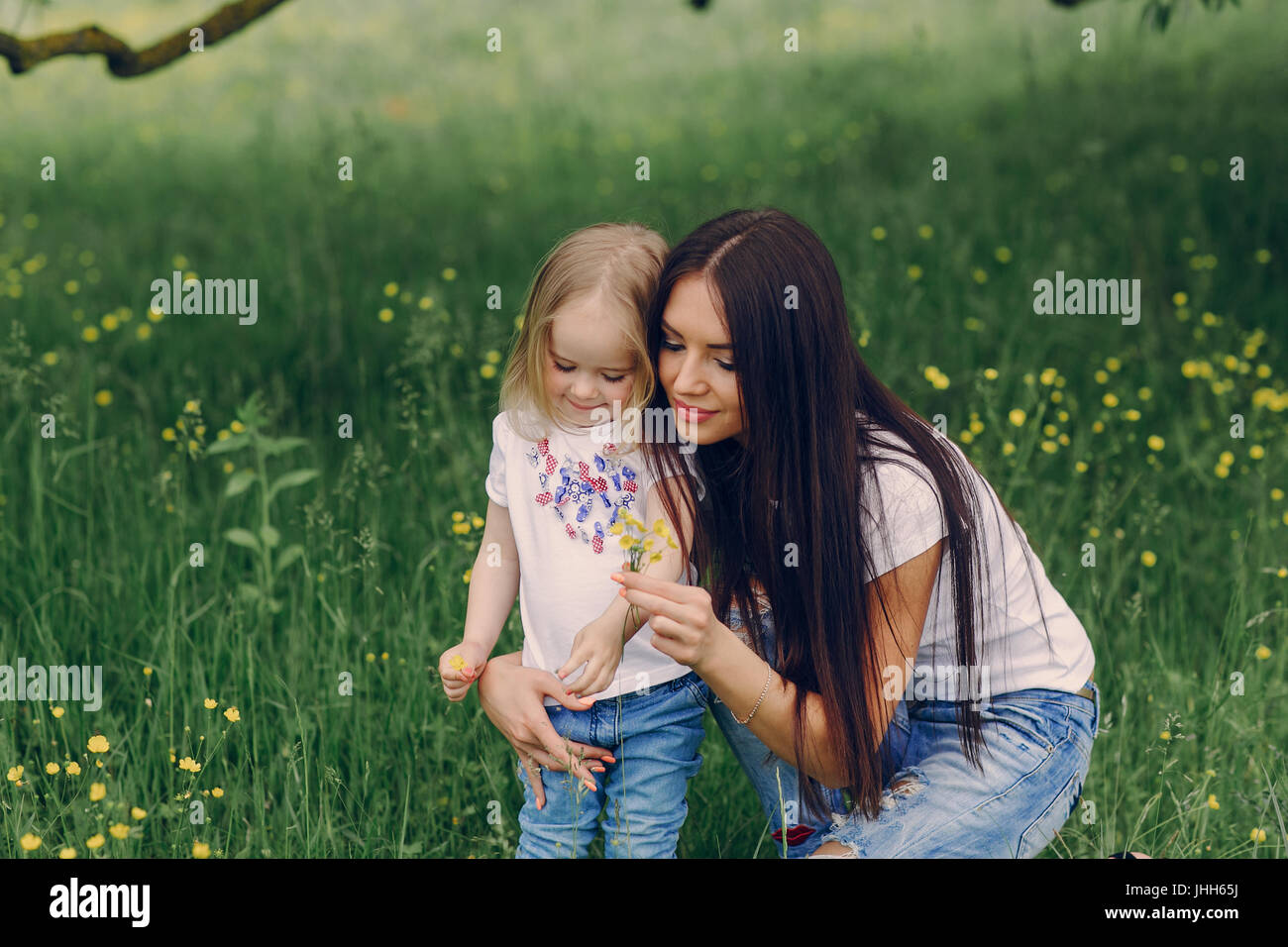 child near tree with mom Stock Photo - Alamy