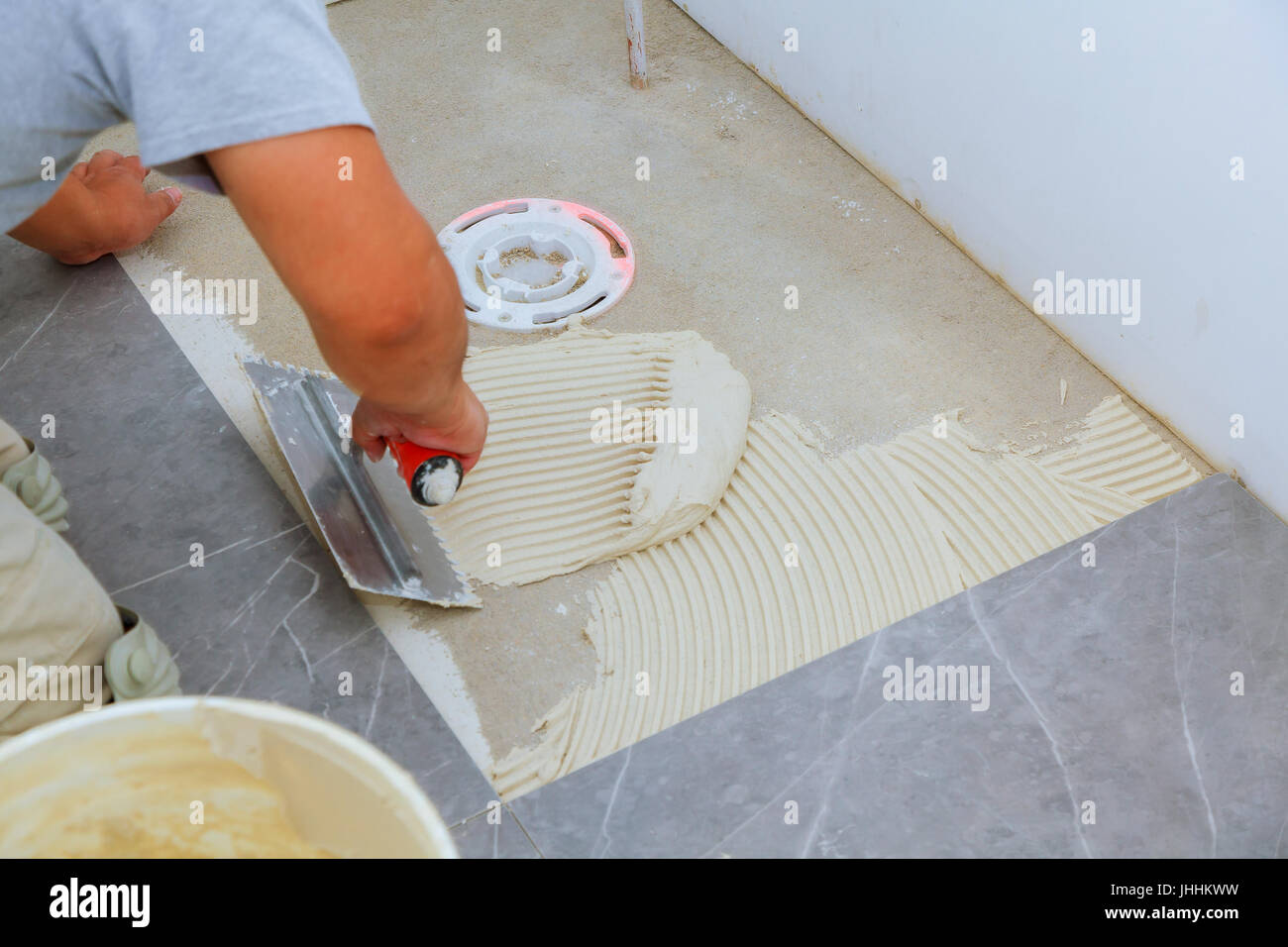 The master the tile industrial tiler builder worker installing floor ...