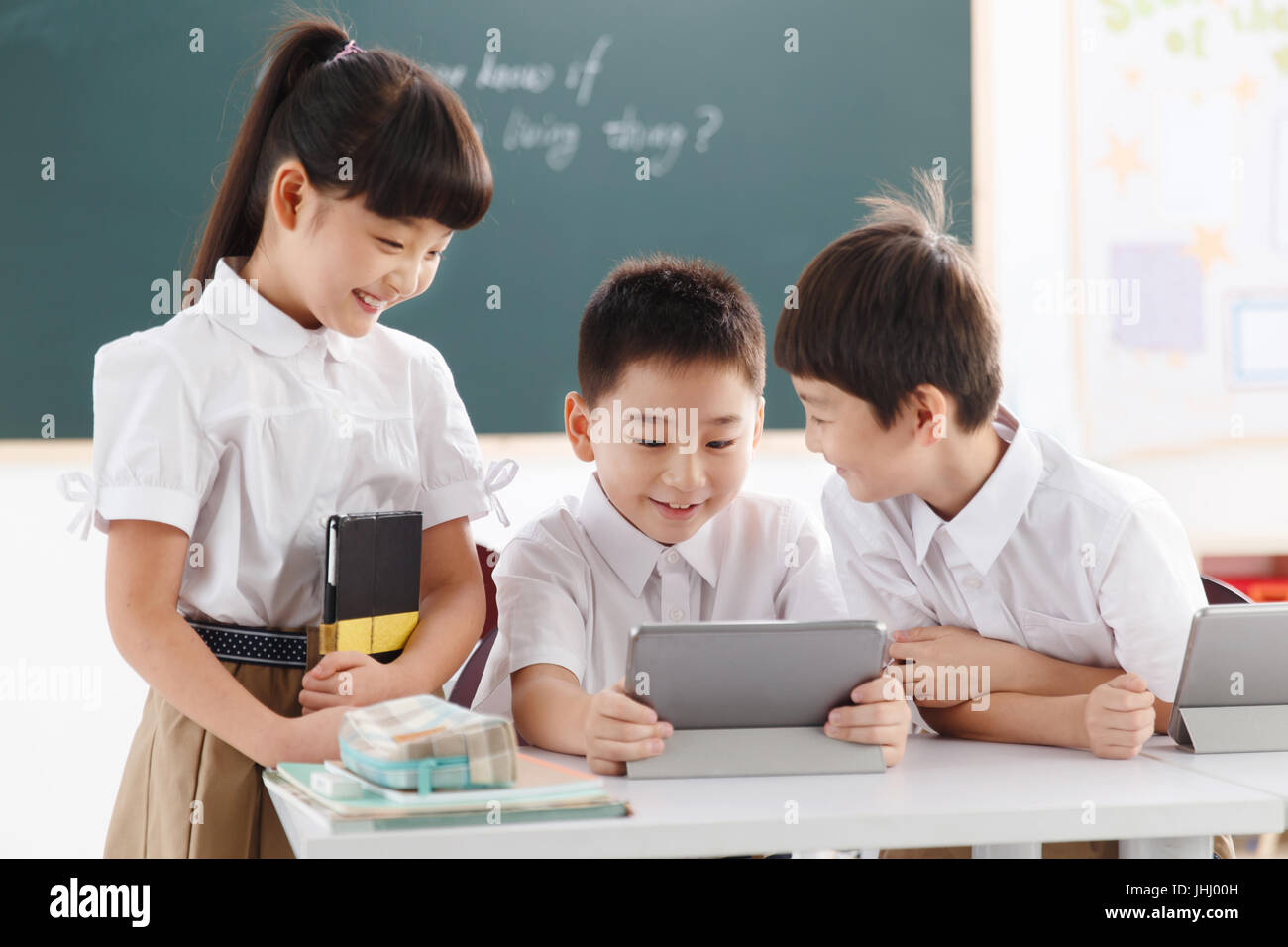 Students using digital tablet in classroom Stock Photo - Alamy