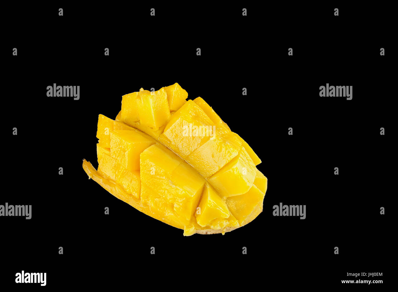 The mango fruit cut into pieces. Isolated on a black background. The ...