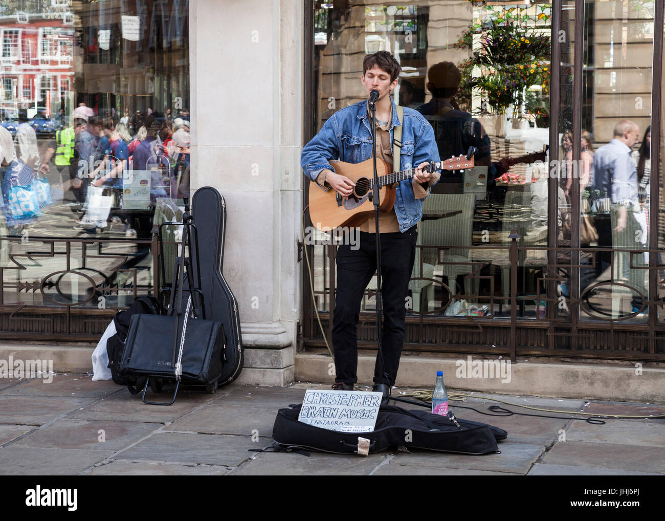 A male busker entertaining the people in the city centre in York ...